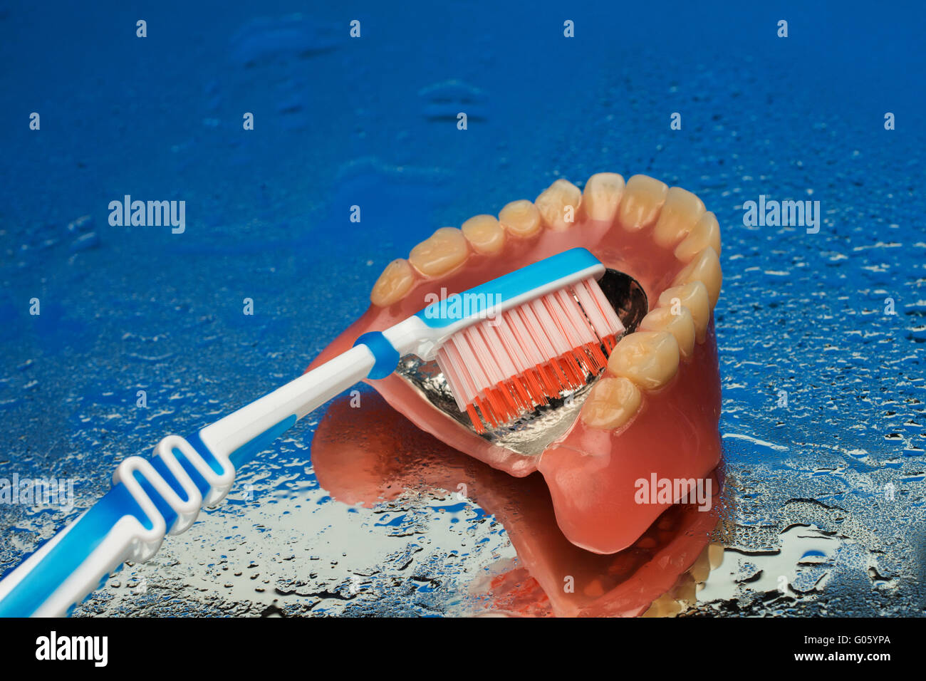 Denture toothbrush blue water drop Stock Photo - Alamy