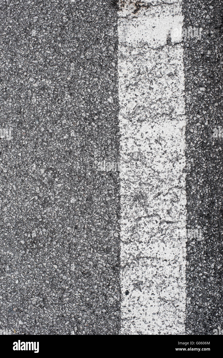 Old asphalt road with big grain stones and white l Stock Photo - Alamy