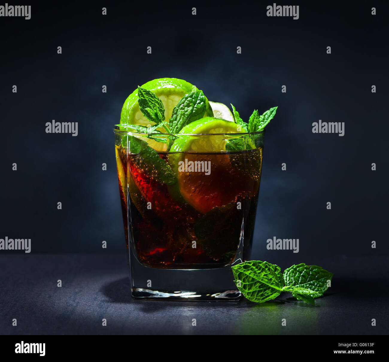 cocktail Cuba libre with lime , ice and peppermint leaves Stock Photo ...