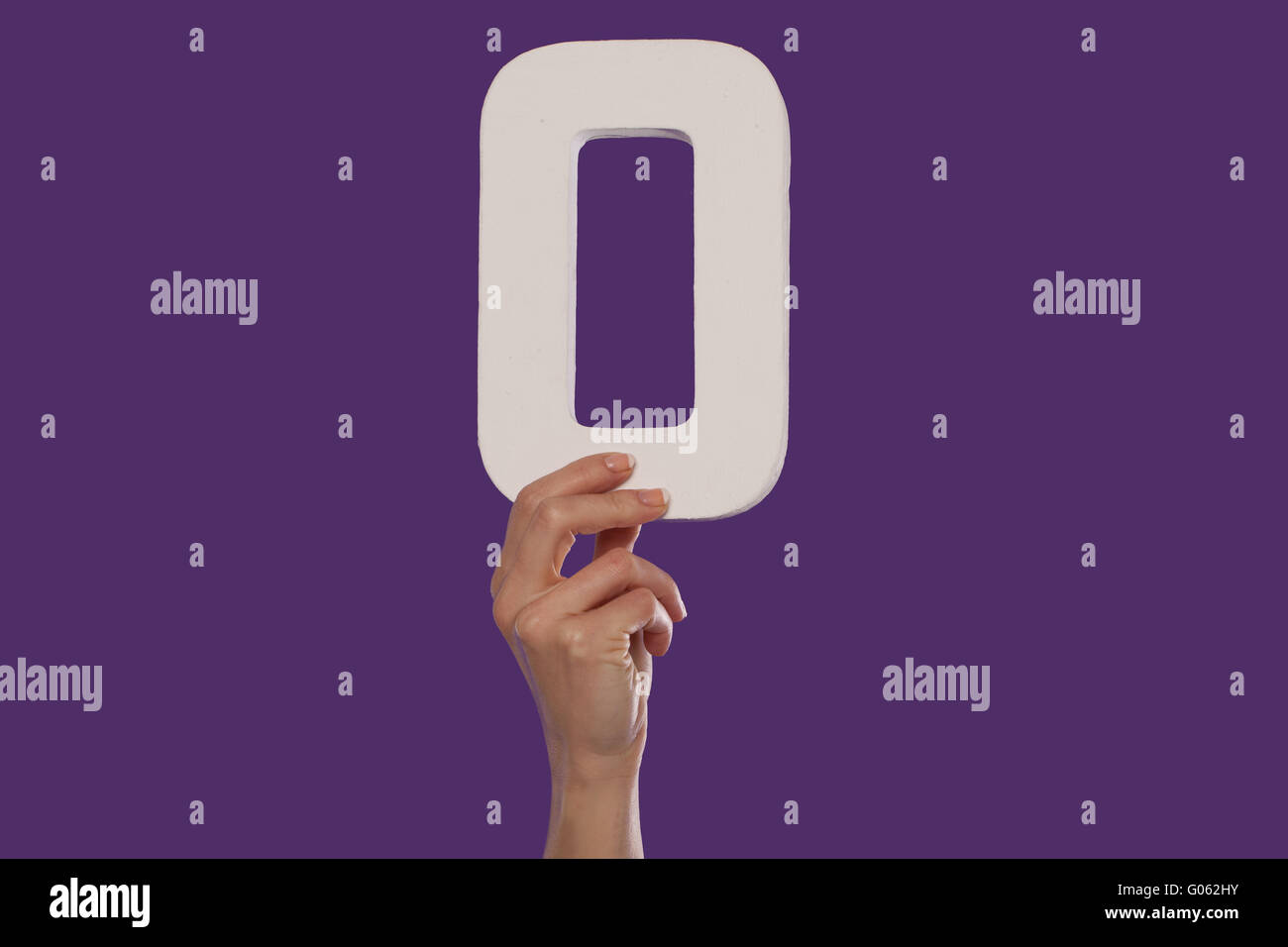 Female hand holding the number 0 from the bottom Stock Photo - Alamy