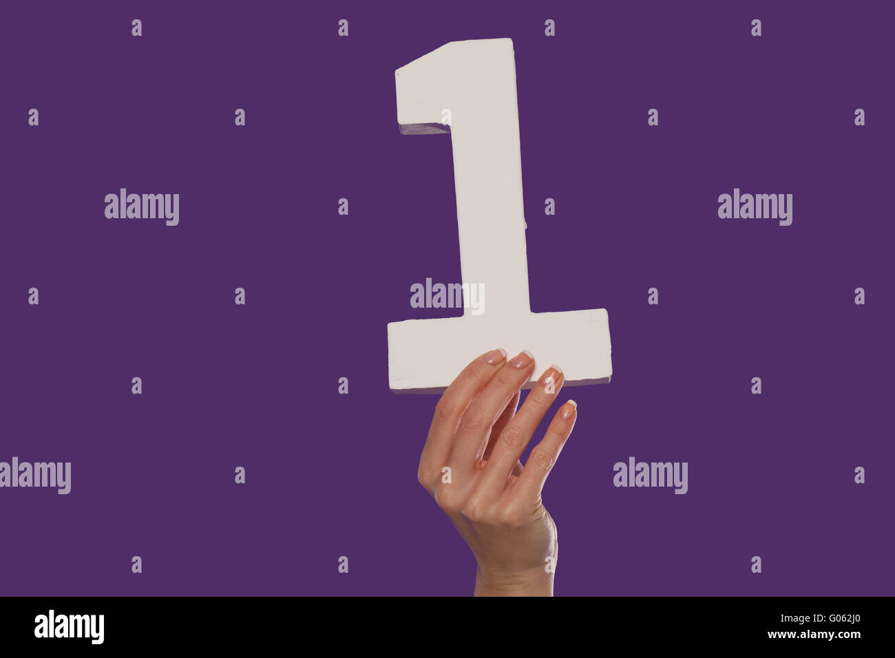 Female hand holding the number 1 from the bottom Stock Photo - Alamy