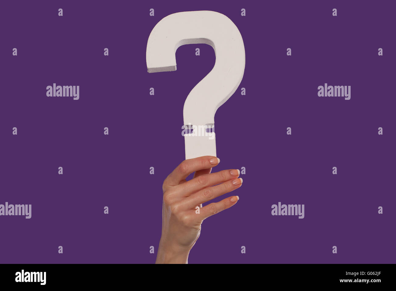 Female hand holding a question mark from the botto Stock Photo - Alamy