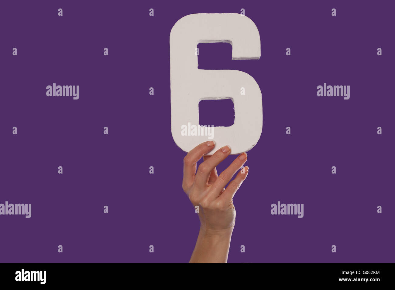 Female hand holding the number 6 from the top Stock Photo - Alamy