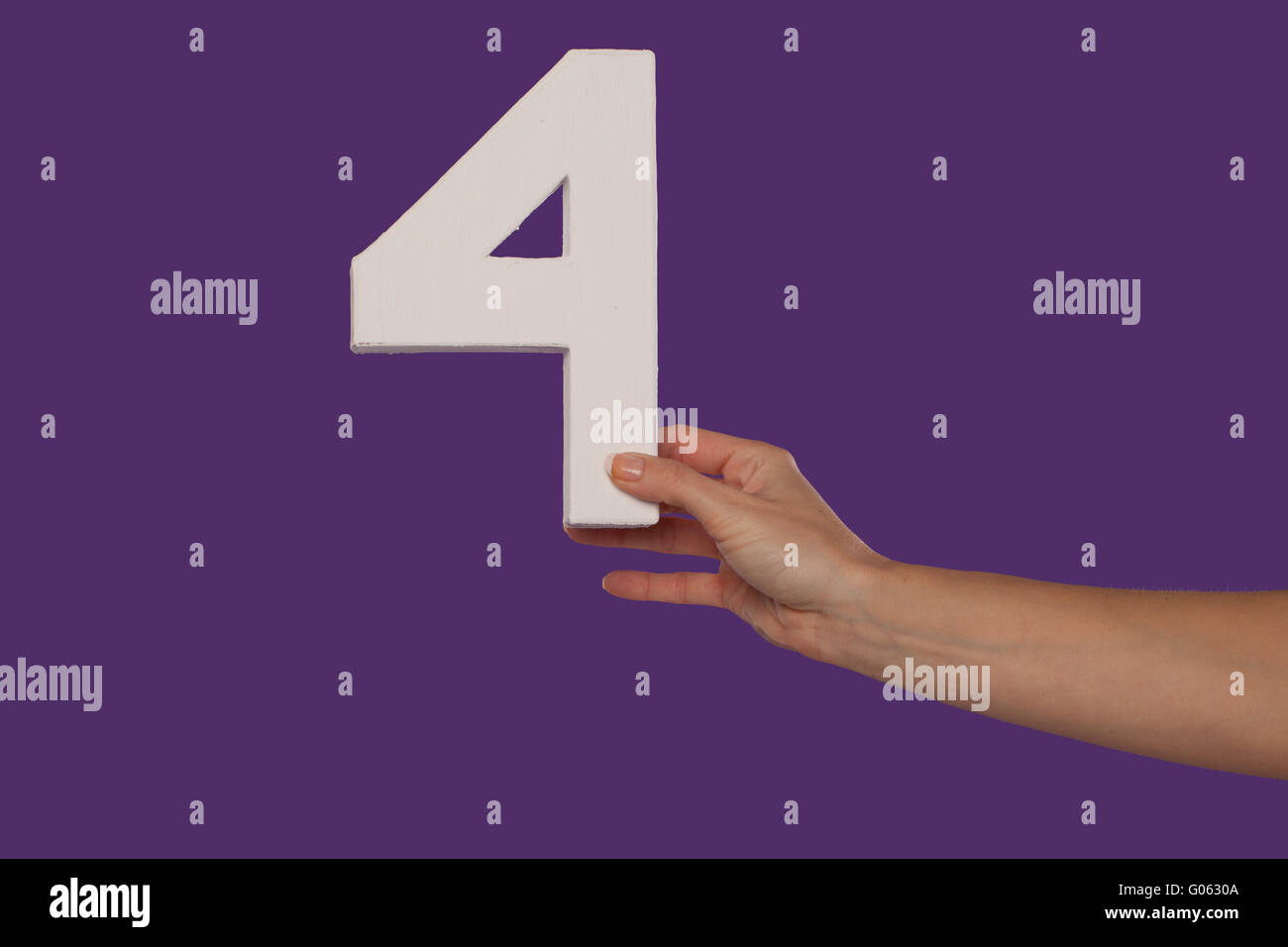 Female hand holding up the number 4 from the right Stock Photo - Alamy