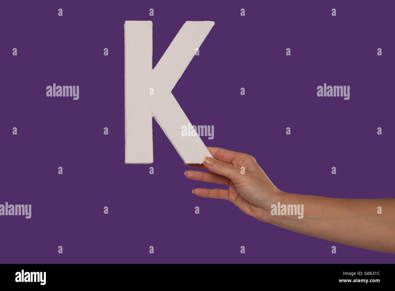 Female hand holding up the letter K from the right Stock Photo - Alamy