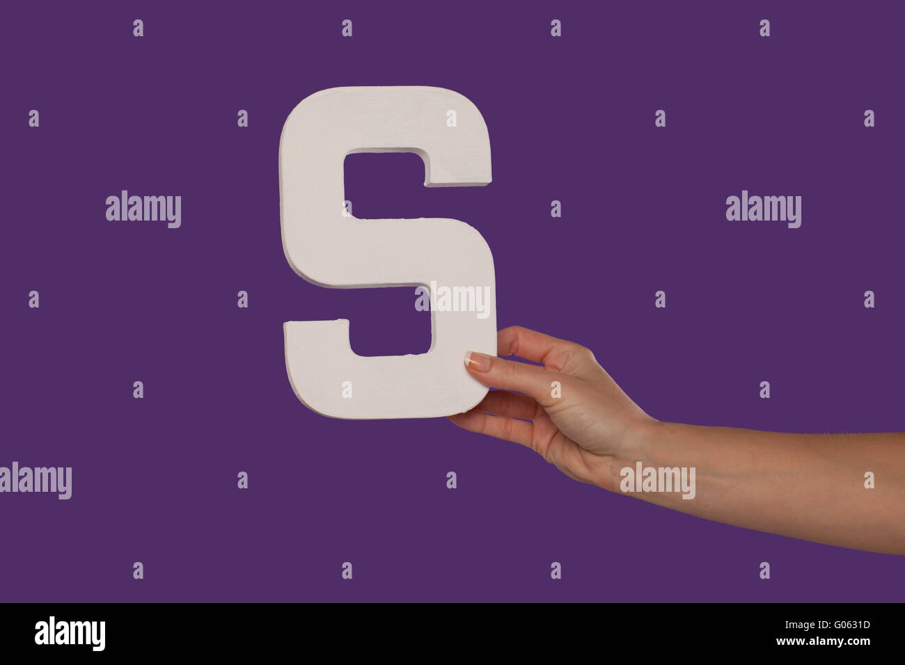 Female hand holding up the letter S from the right Stock Photo - Alamy