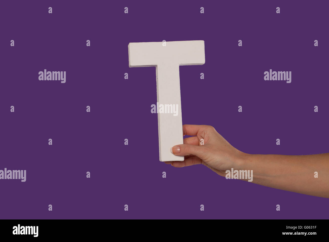 Female hand holding up the letter T from the right Stock Photo - Alamy