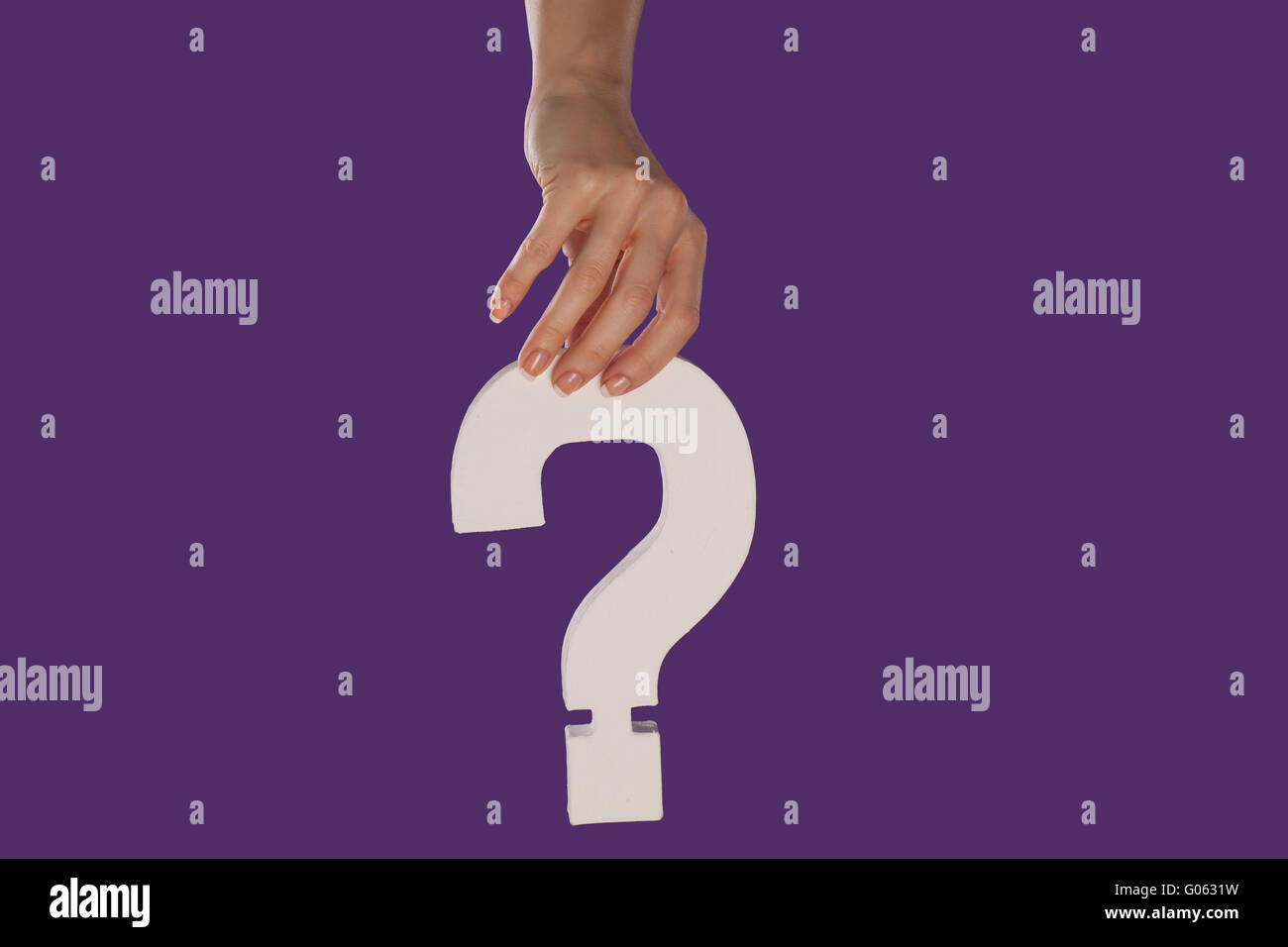 Female hand holding up a question mark from the to Stock Photo - Alamy