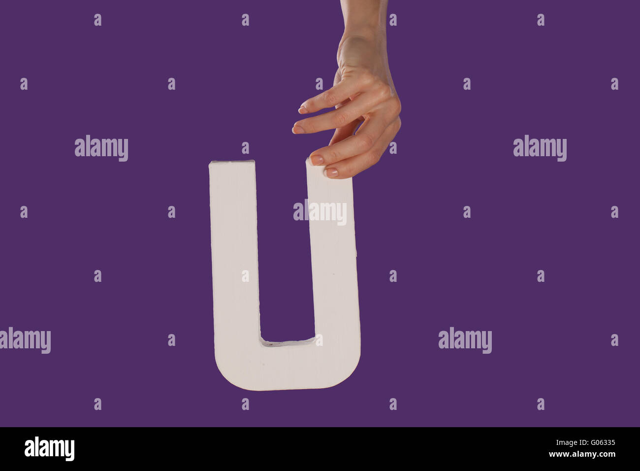 Female hand holding up the letter U from top Stock Photo - Alamy