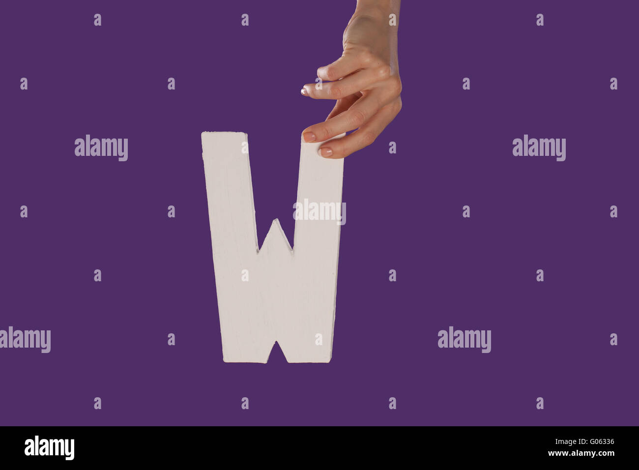 Female hand holding up the letter W from top Stock Photo - Alamy