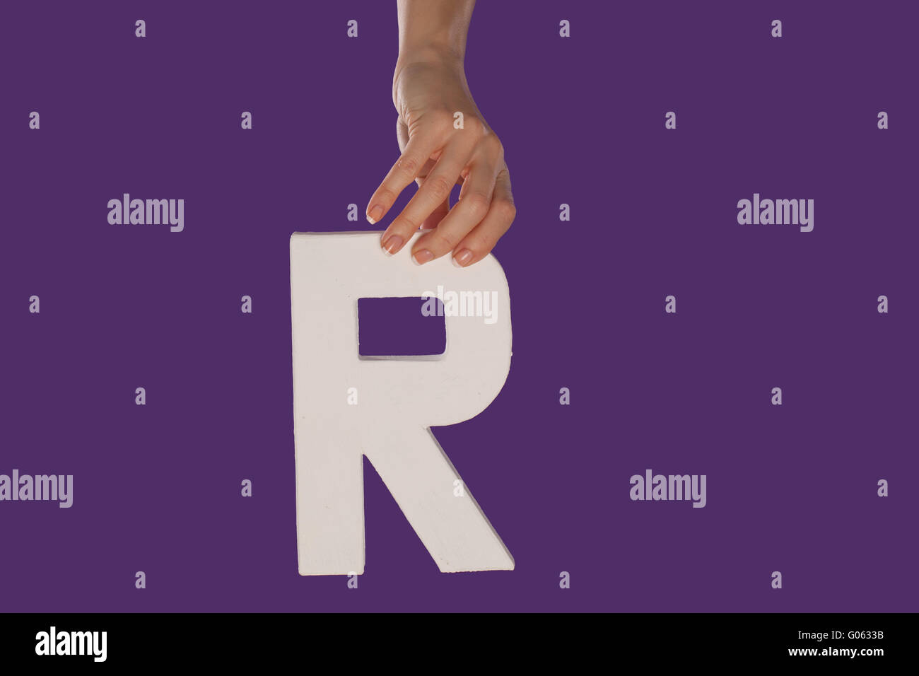 Female hand holding up the letter R from top Stock Photo - Alamy