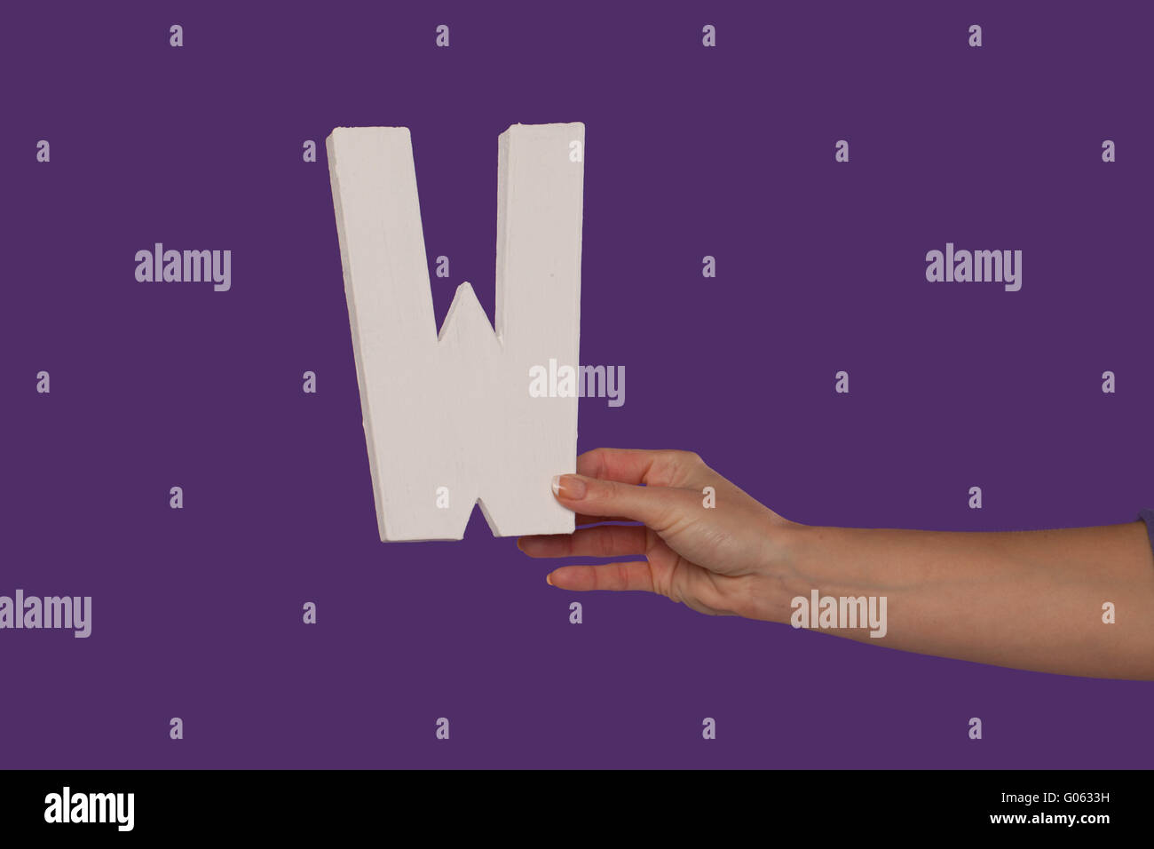 Female hand holding up the letter W from the right Stock Photo - Alamy