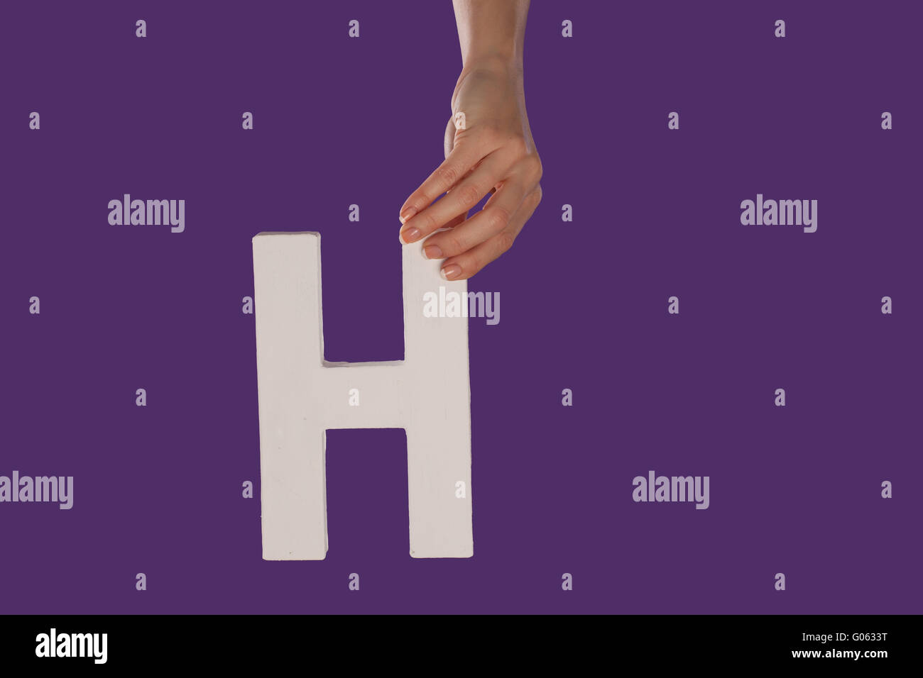 Female hand holding up the letter H from top Stock Photo - Alamy