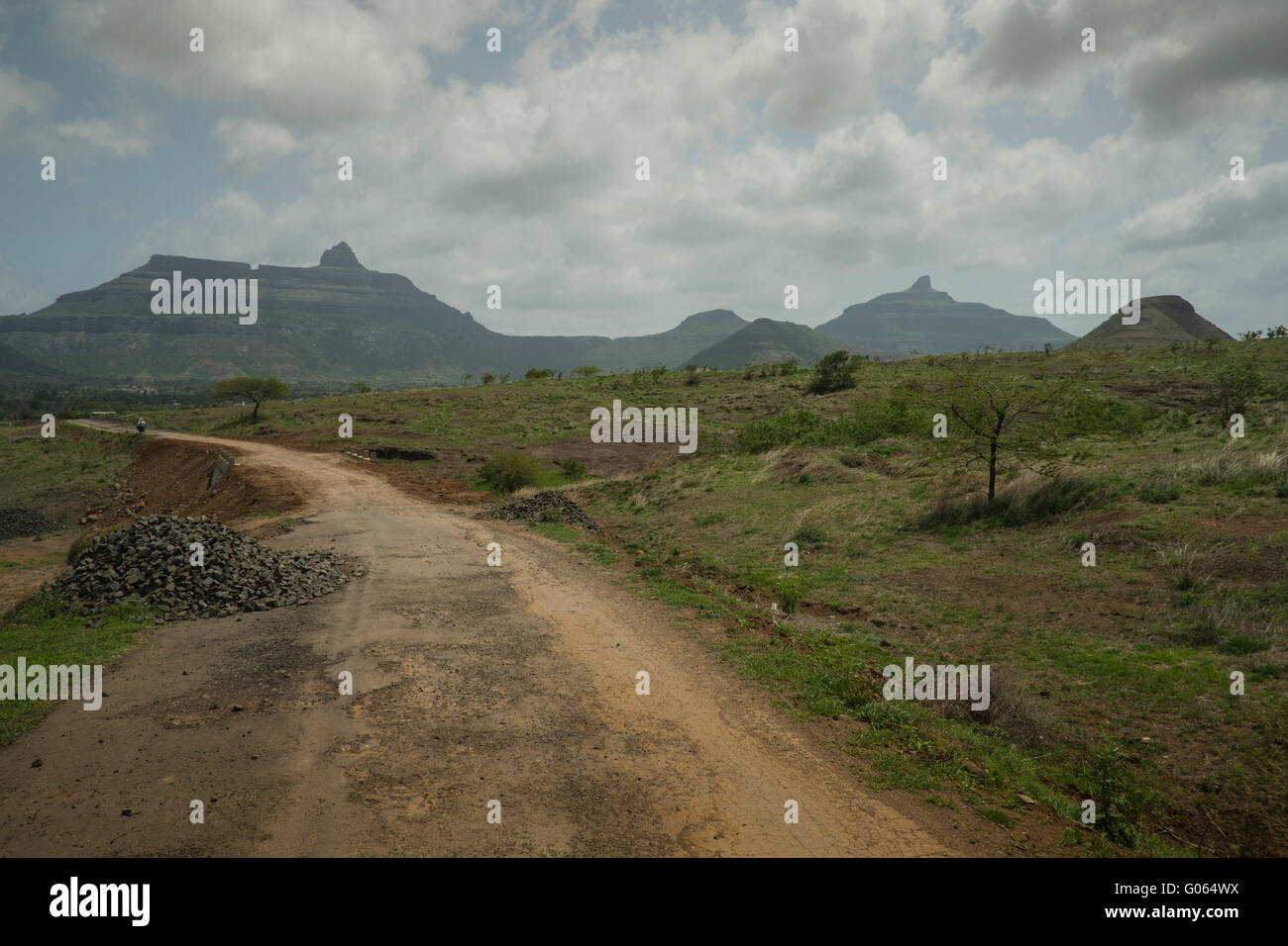 The dusty rural road to fort Dodap in the Satmala Range of the Sahyadri ...