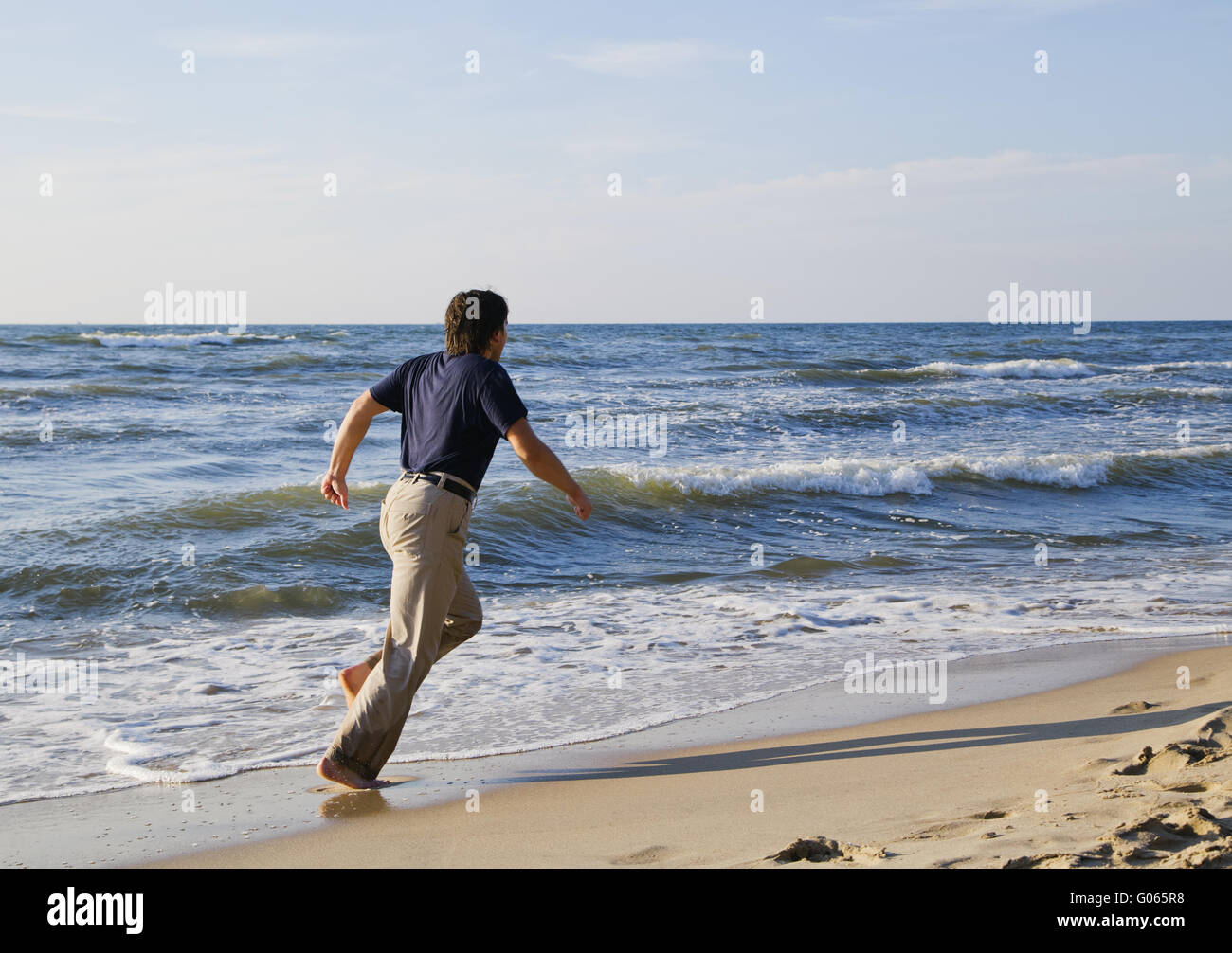 Man running along seashore hi-res stock photography and images - Alamy