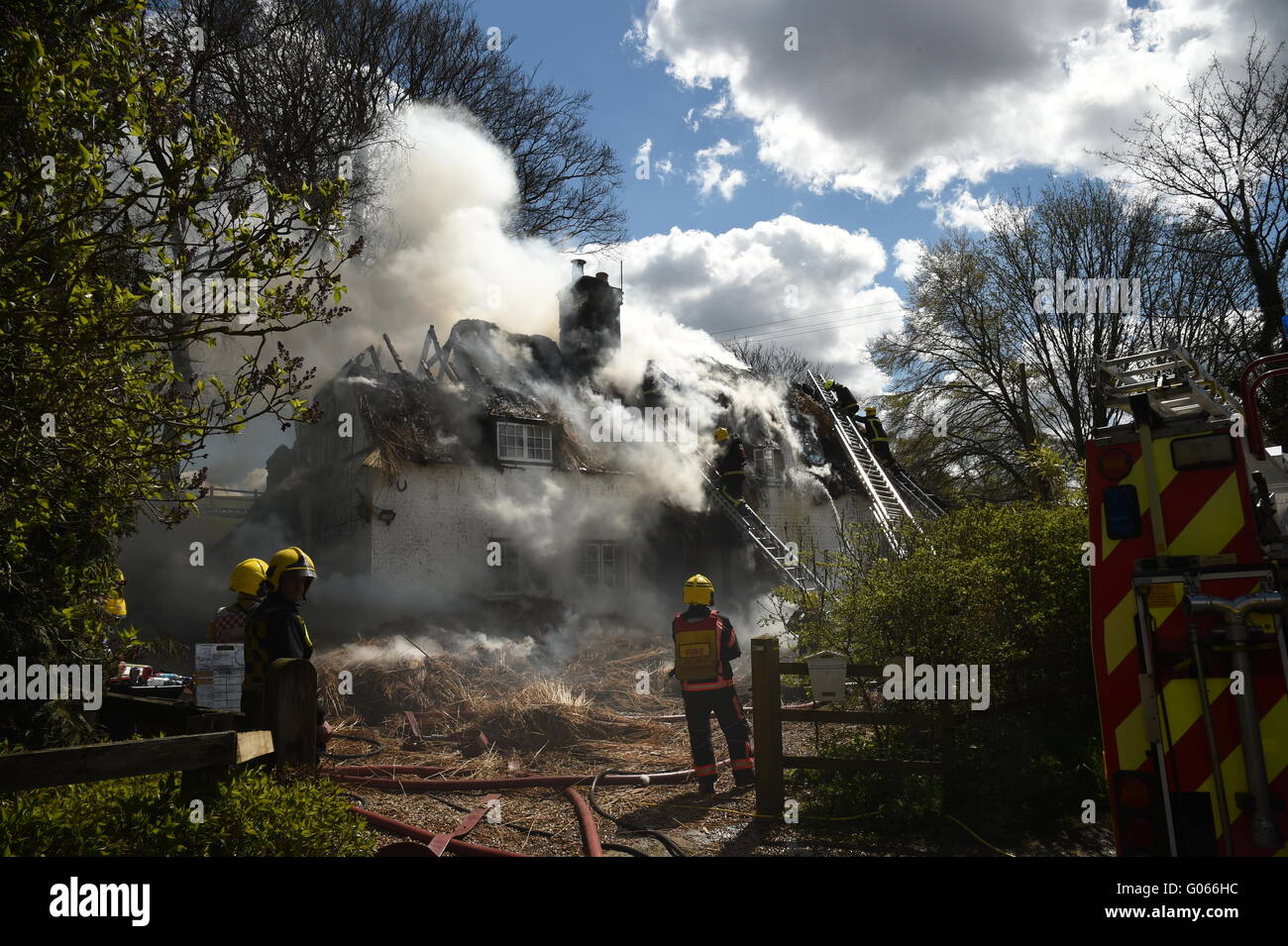 Thatch cottage fire Stock Photo - Alamy