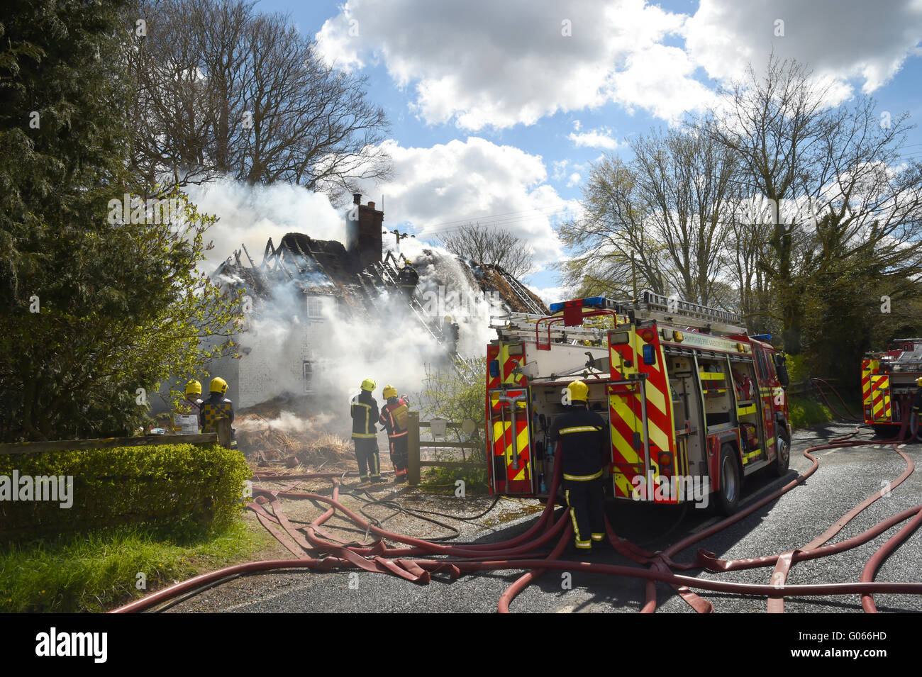 Thatch cottage fire Stock Photo - Alamy