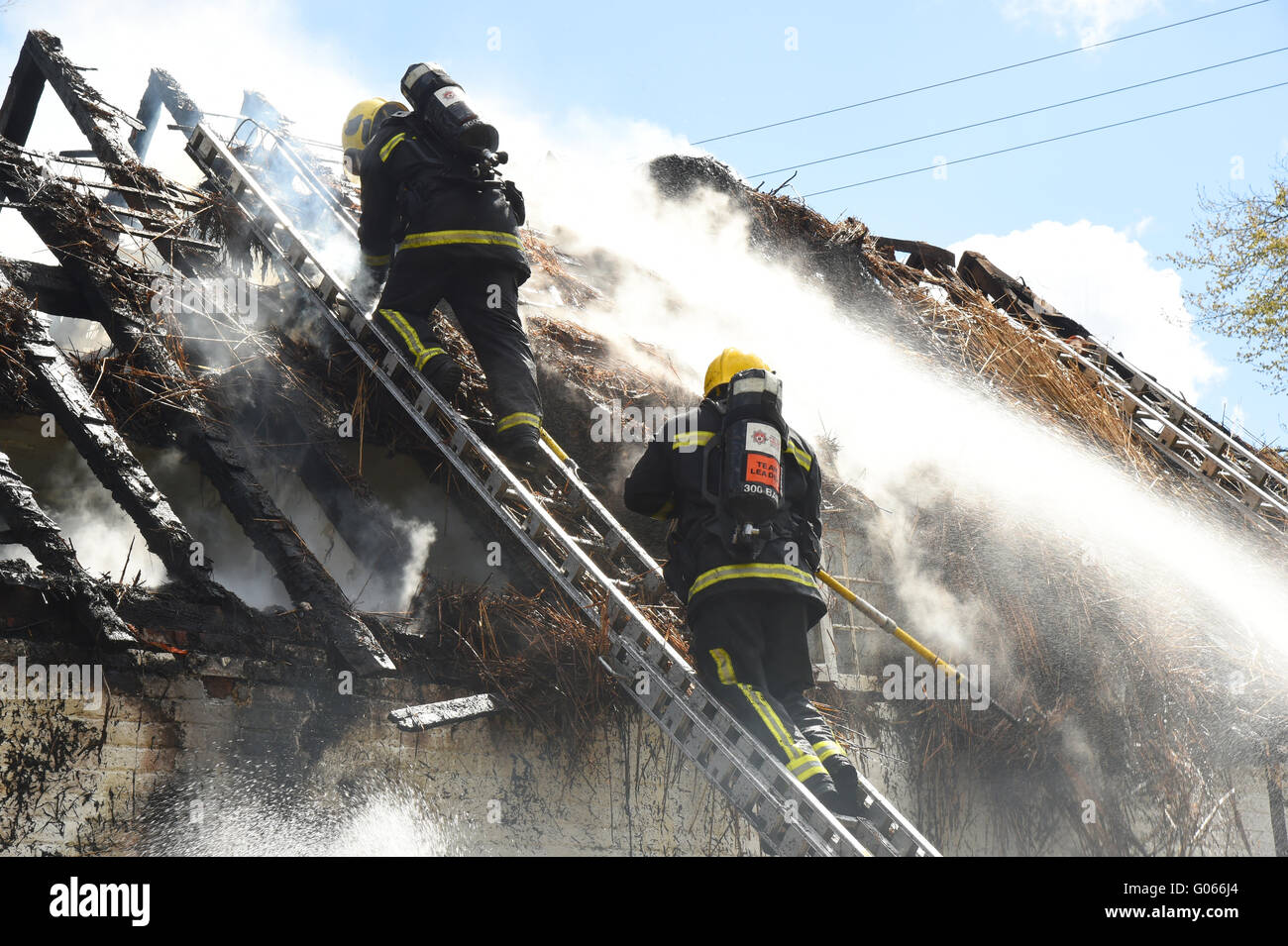 Thatch cottage fire Stock Photo - Alamy