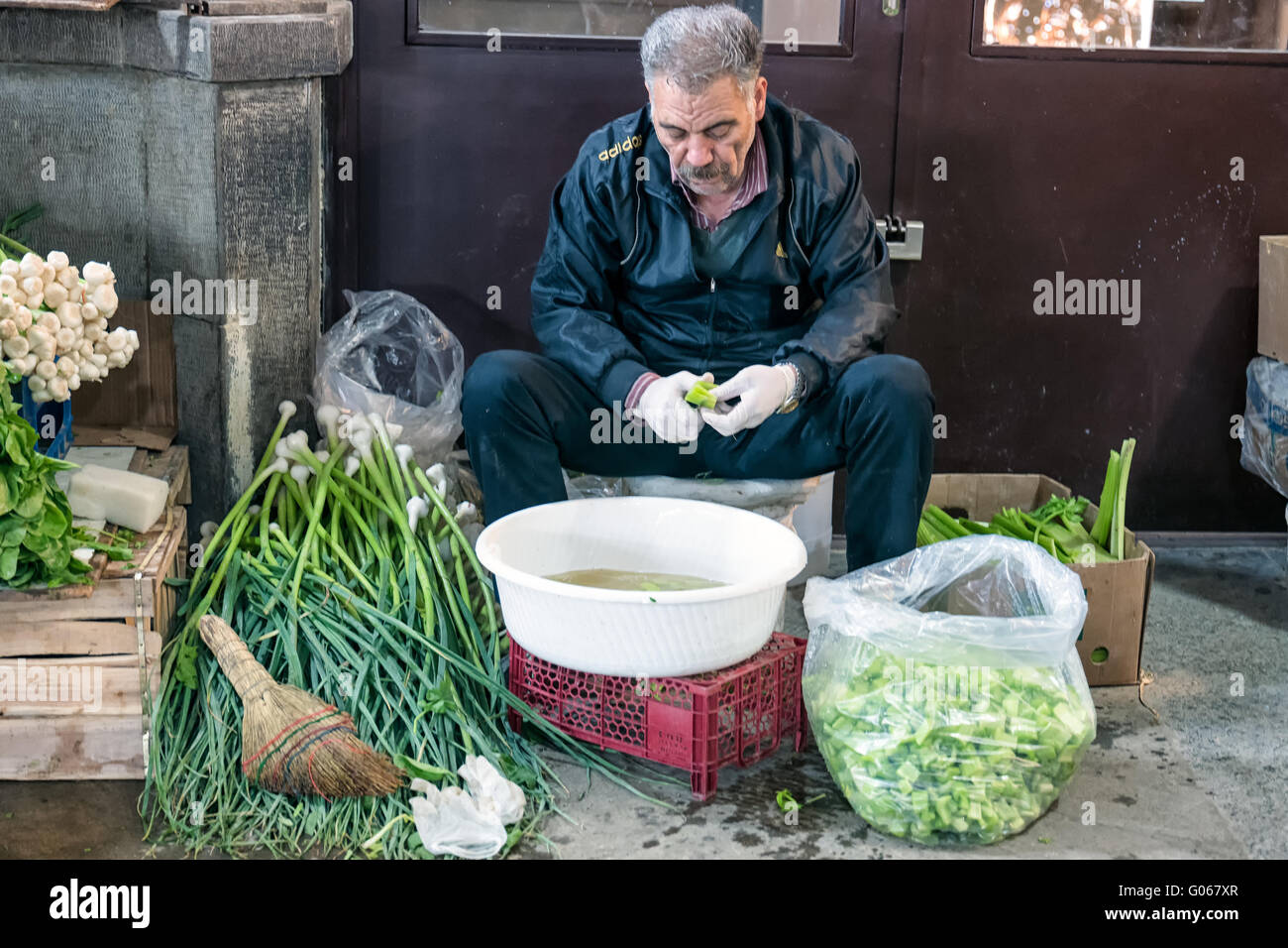 Worker cutting celery for sale in a local market in Tehran, Iran Stock ...