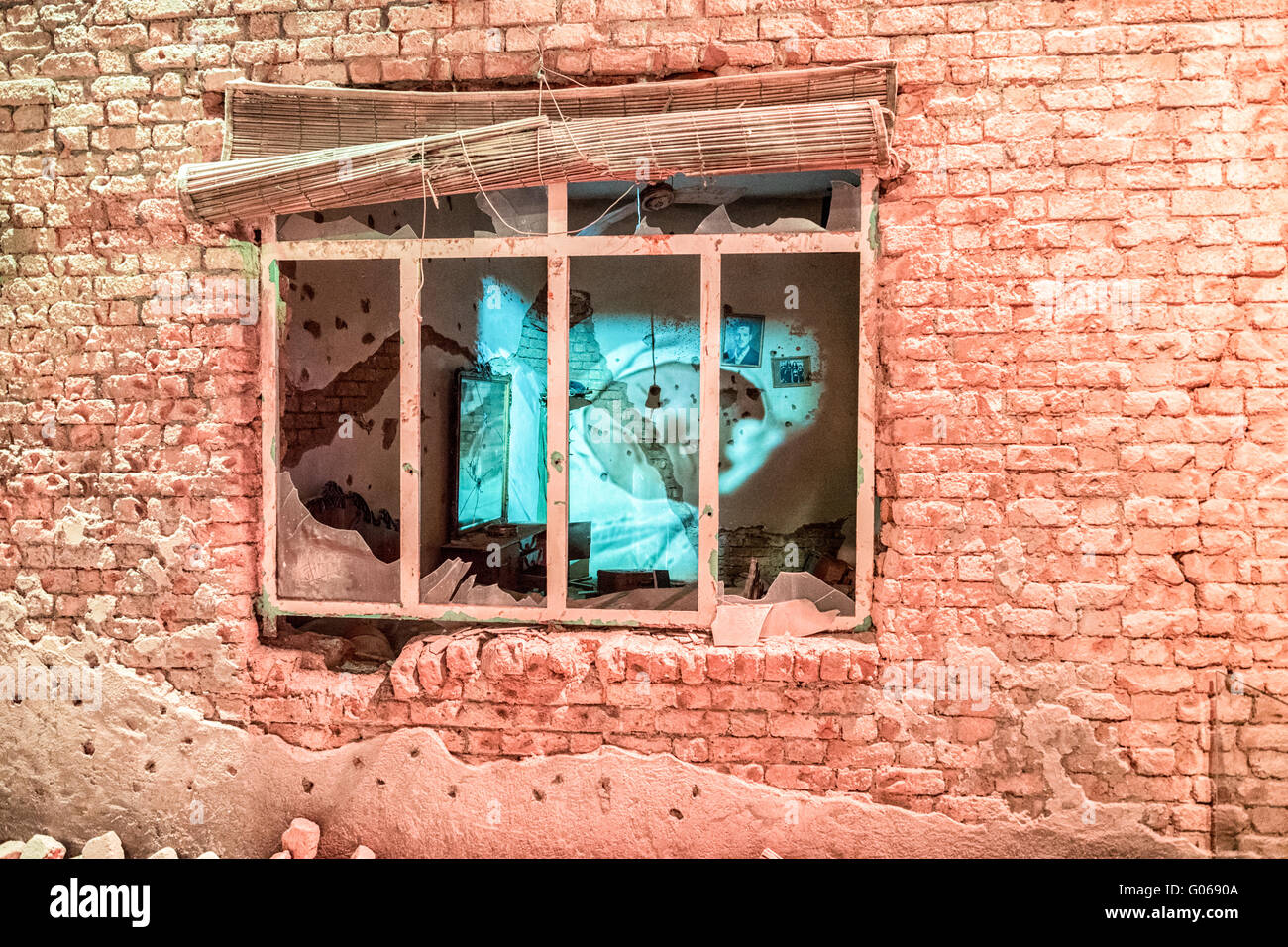 Display of bullet-riddled home with projection of baby in window in the ...