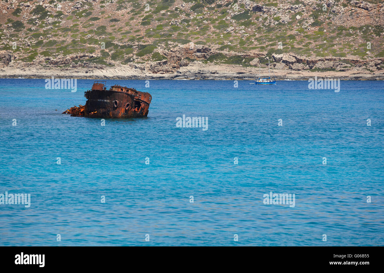 Shipwreck and sailboat at Imeri Gramvousa Bay. Crete. Greece ...