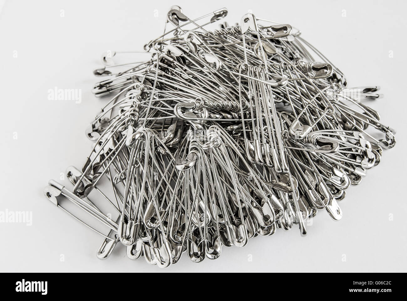 Silver colored big safety pins pile closeup Stock Photo - Alamy