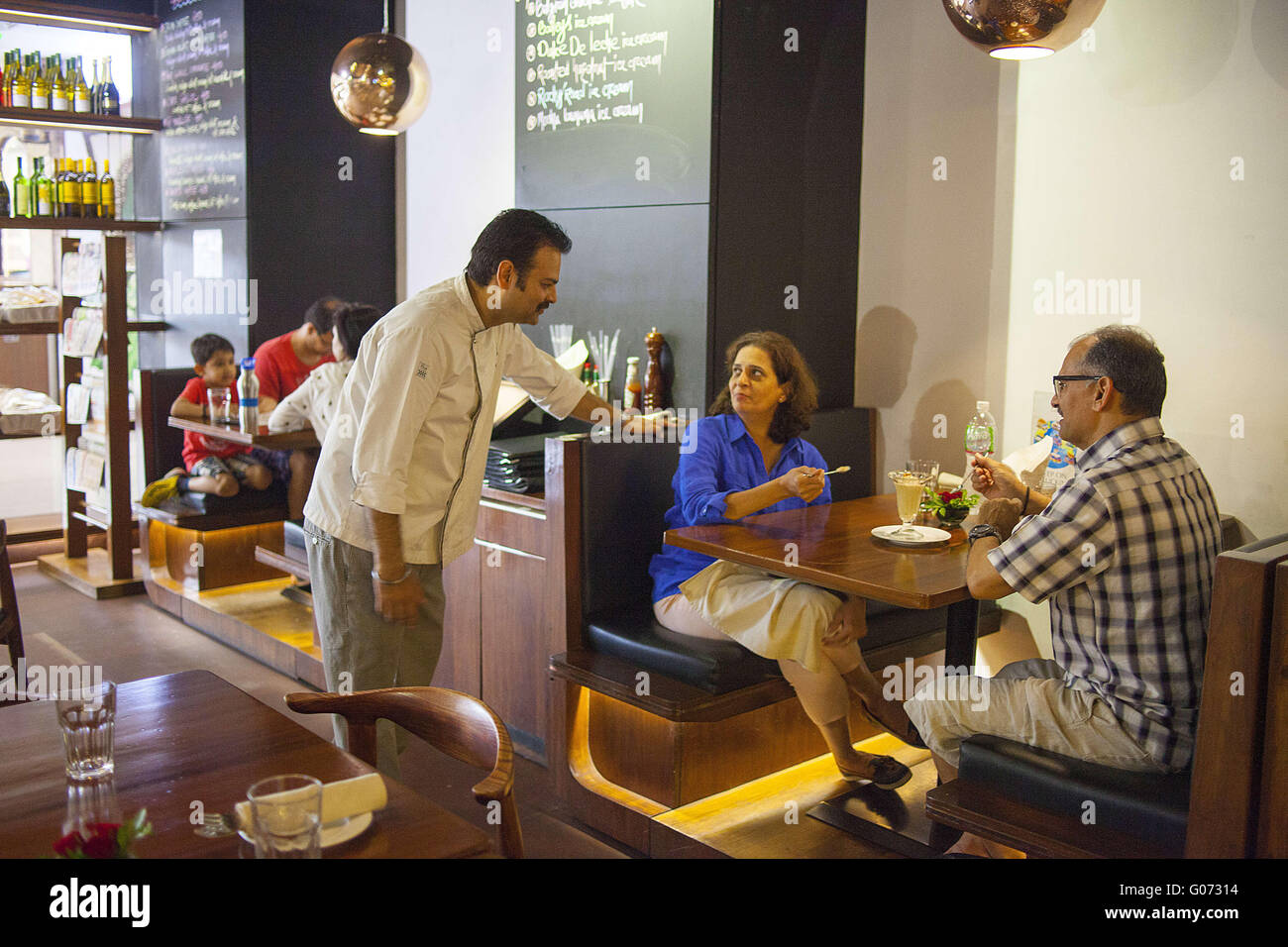 Indian chef serving food in restaurant High Resolution Stock ...