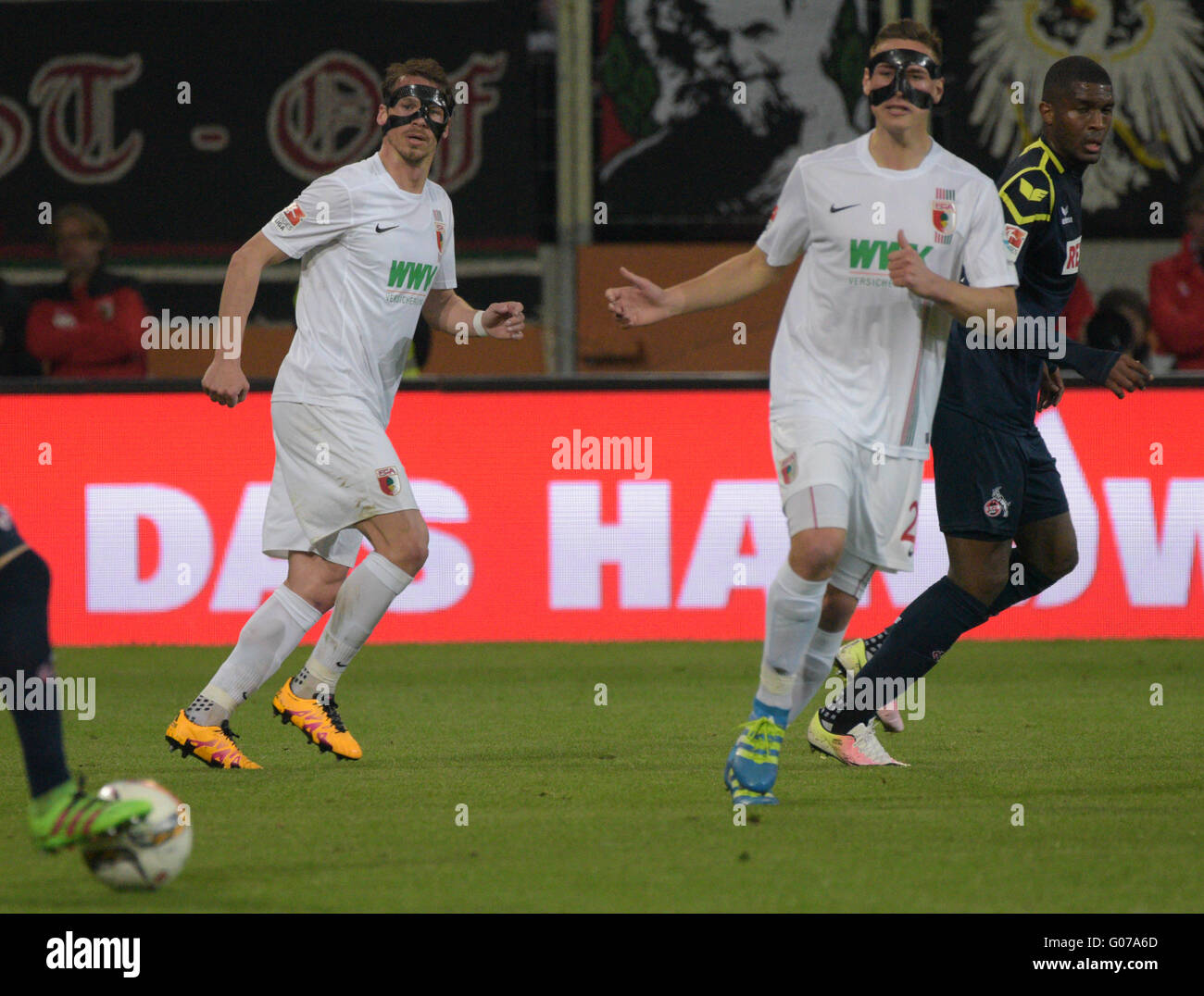 Augsburg's Markus Feulner (l) and Dominik Kohr playing with face masks ...