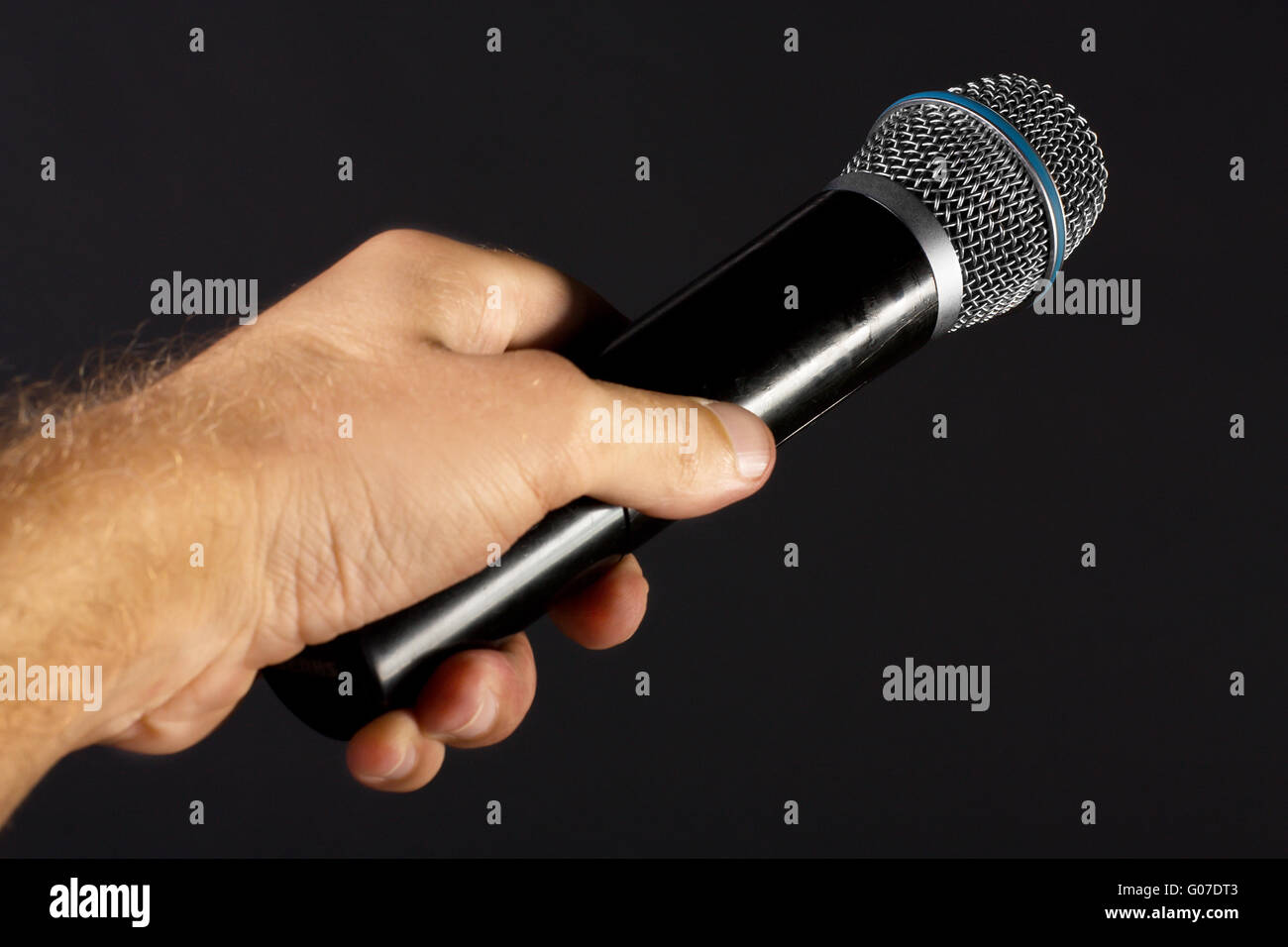 Classic microphone in performer hand isolated on black background Stock ...
