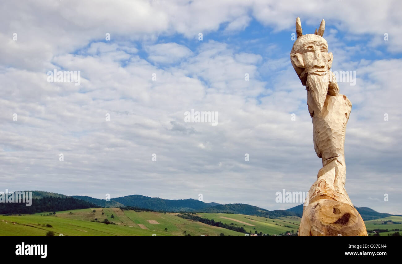 Wooden devil, sculpture on the sky Stock Photo - Alamy