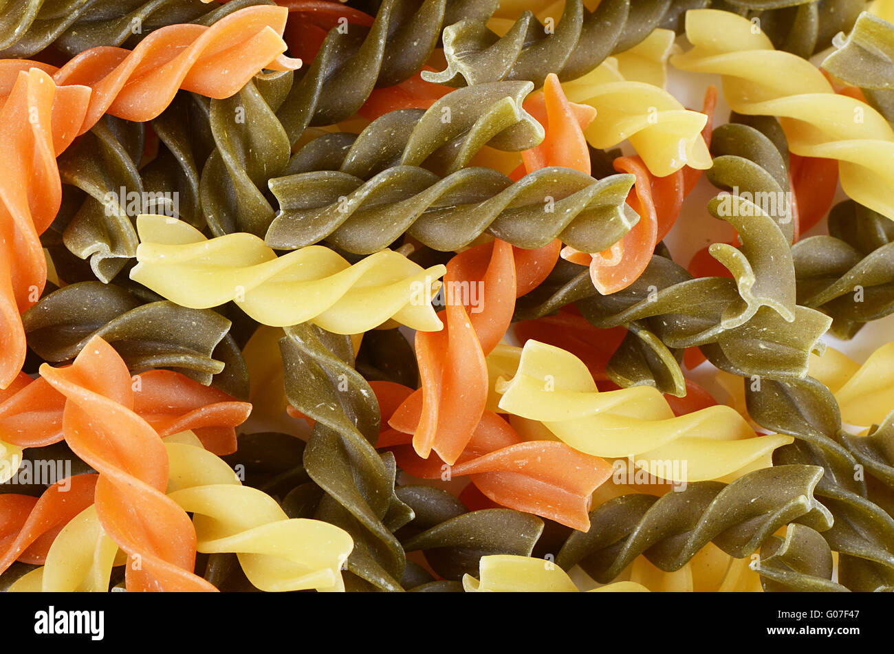 Raw colored pasta fusilli isolated on white background Stock Photo - Alamy
