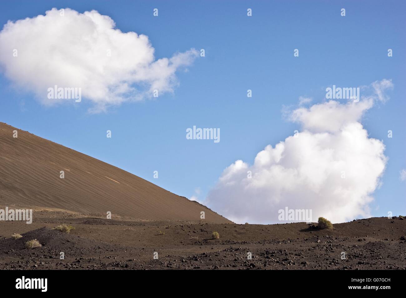 Brown vulcano with clouds Stock Photo - Alamy