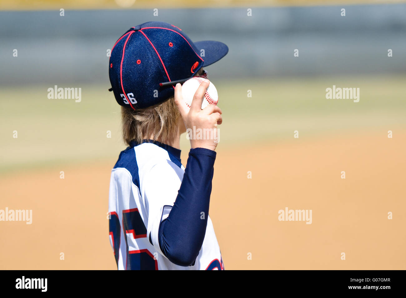little league baseball player holding a ball Stock Photo - Alamy
