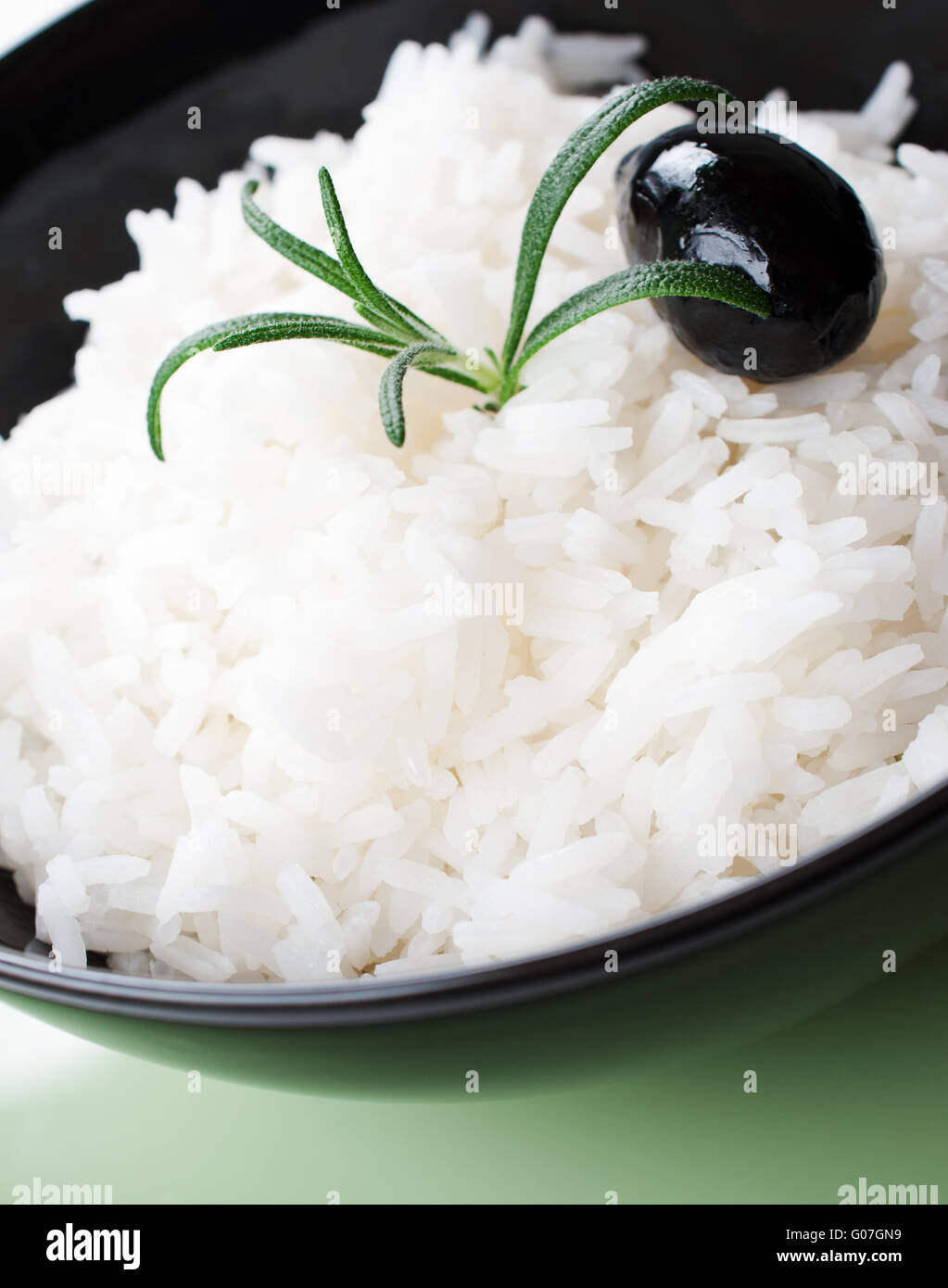 A bowl of cooked Rice with rosemary and olive Stock Photo - Alamy