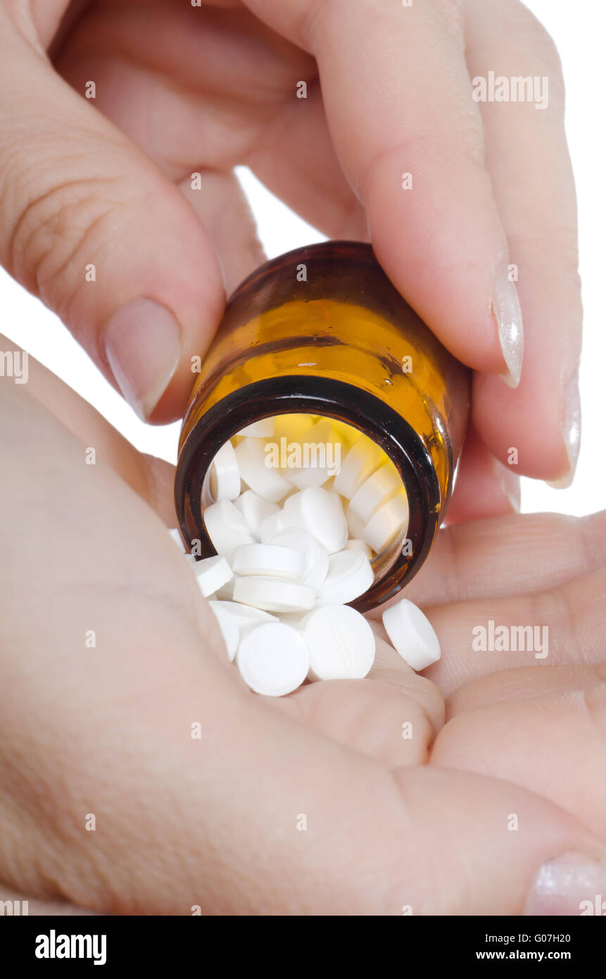 Hands full of pils isolated on white background Stock Photo - Alamy