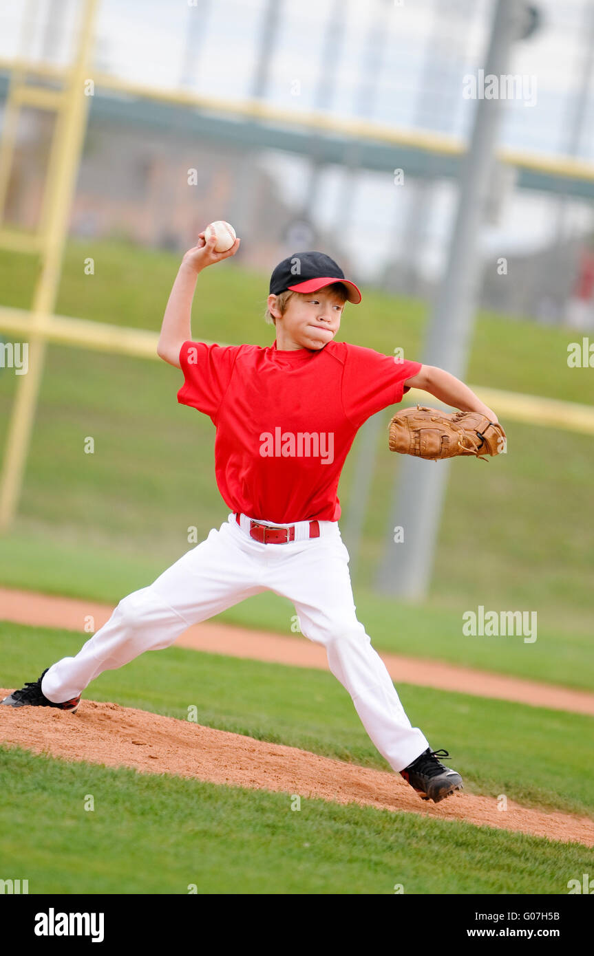 Pitcher in red throwing the pitch Stock Photo - Alamy