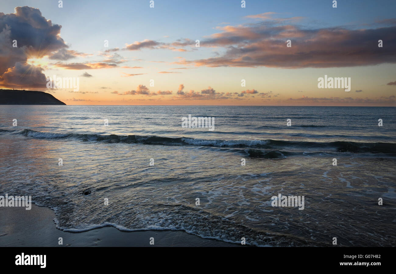 Beach sunset with clouds hi-res stock photography and images - Alamy