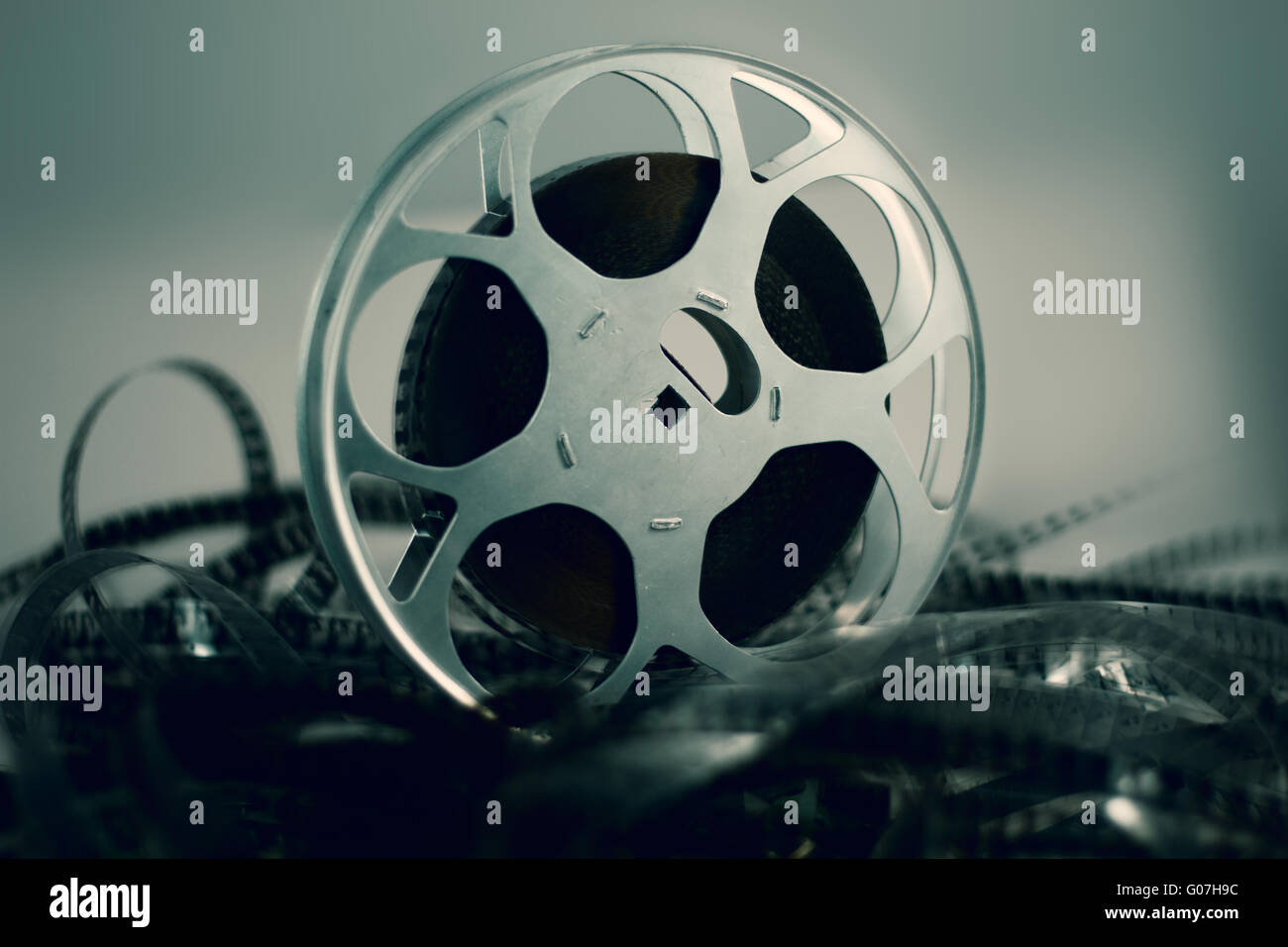 Film reel with celluloid around green atmosphere Stock Photo - Alamy