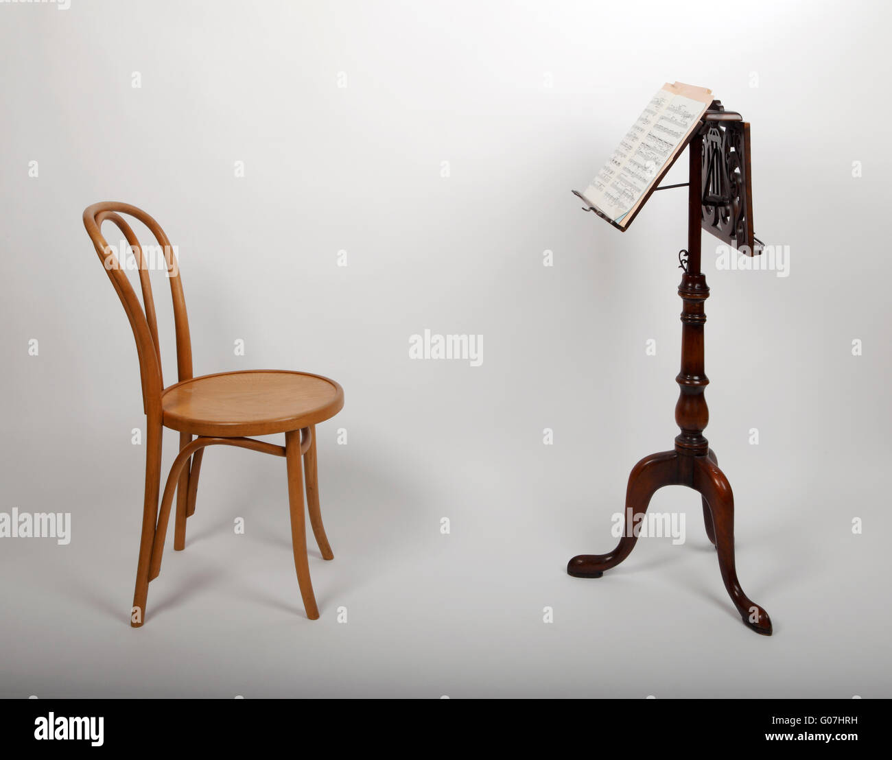 vintage music stand with music on it and a chair ready to play on Stock ...