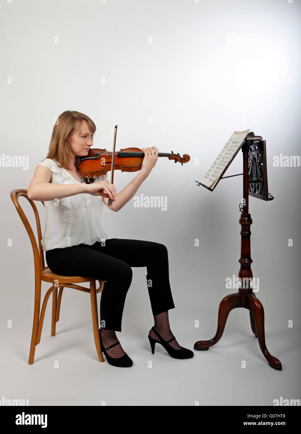 Woman Playing Violin In Orchestra