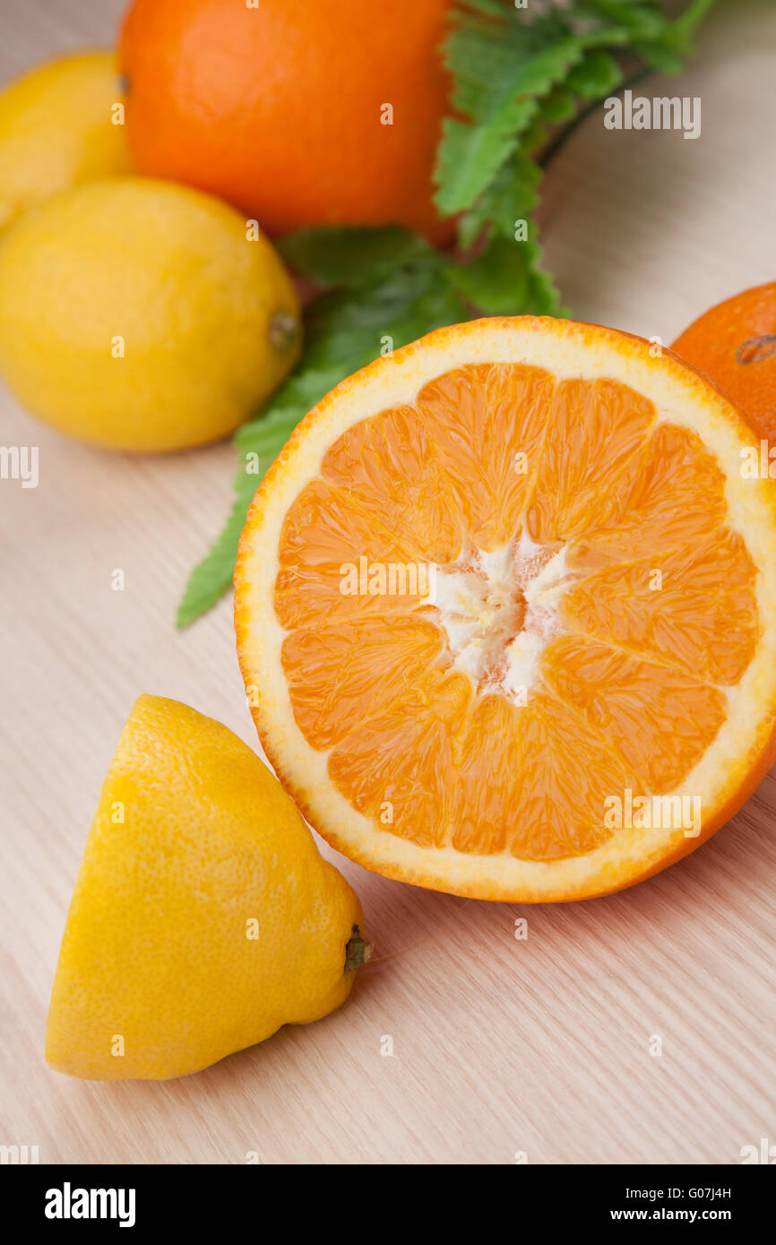 two half of fresh lemon and orange on wooden tabl Stock Photo - Alamy