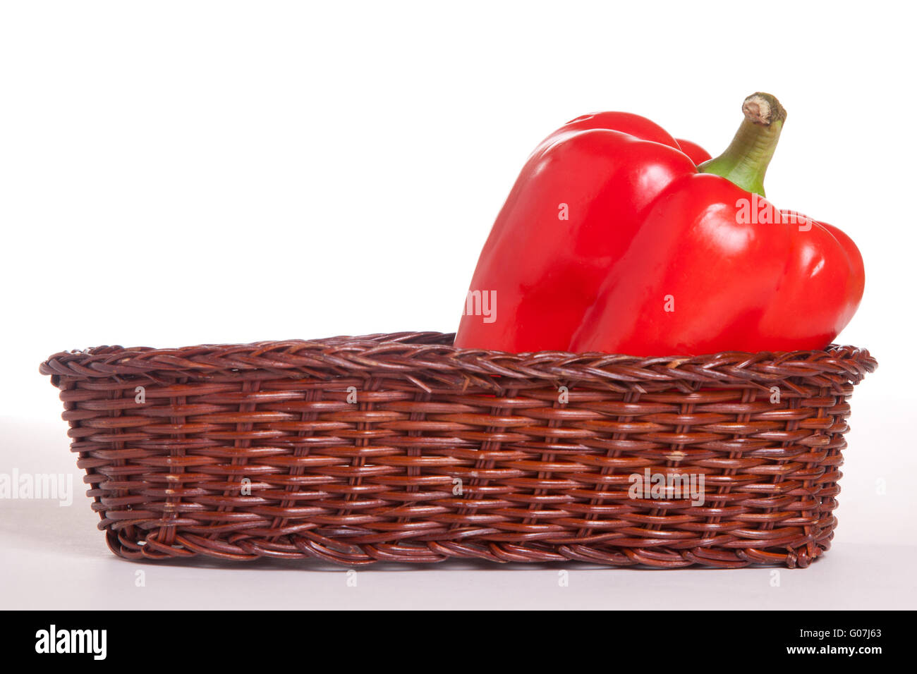red pepper inside little basket isolated on white Stock Photo - Alamy