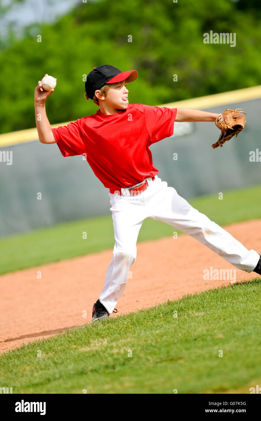 Youth ball player throwing ball Stock Photo - Alamy
