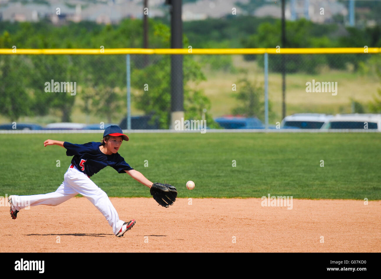 Little league boy reach out to catch ball Stock Photo - Alamy