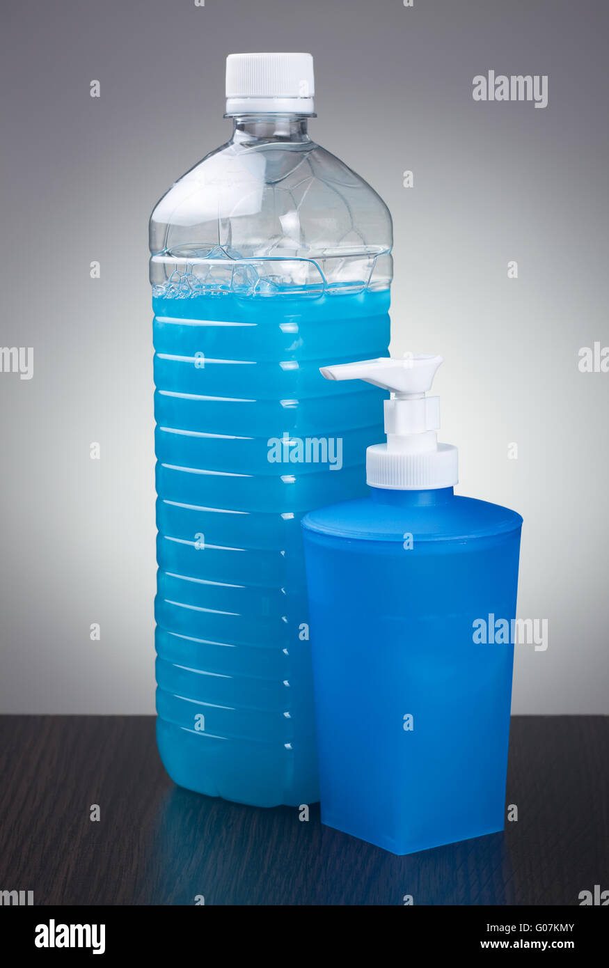 blue liquid soap on the table over grey background Stock Photo - Alamy