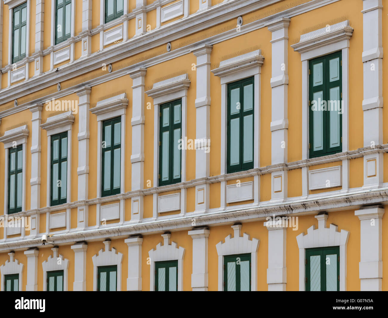 European Style Yellow Building with Green Window Stock Photo - Alamy