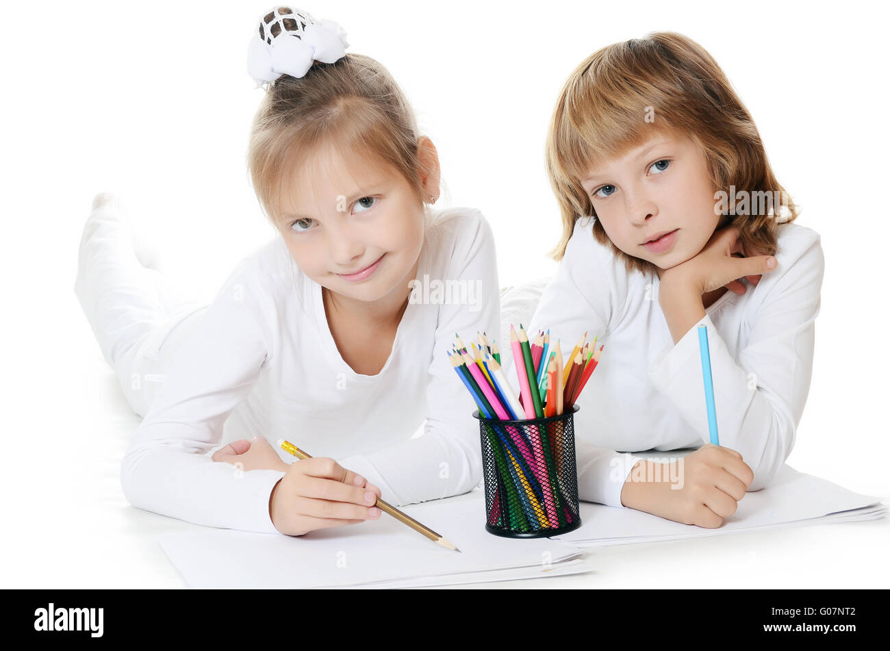 Two girls draw color pencils isolated on white Stock Photo - Alamy