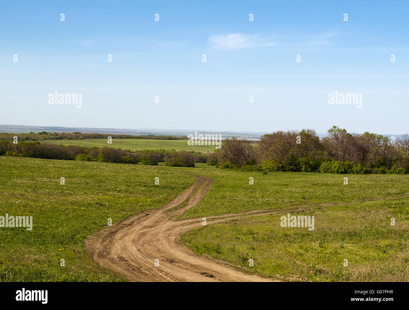 Country road running through field Stock Photo - Alamy