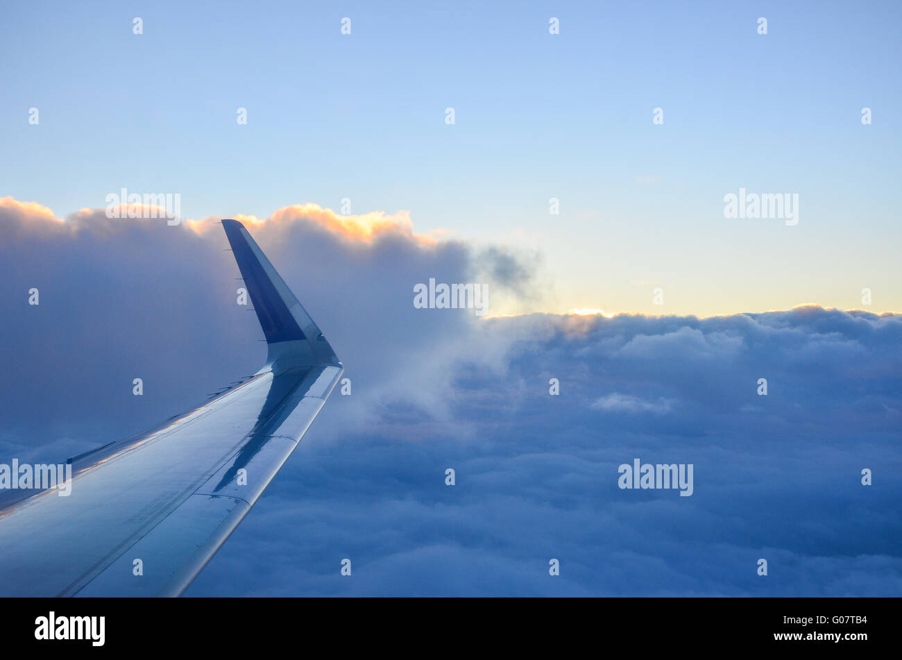 IndiGo Airlines flight window view of clouds with sunset orange lining ...