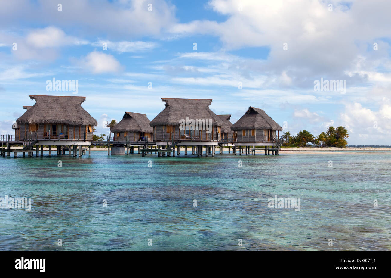 seacoast with palm trees and small houses on water Stock Photo - Alamy